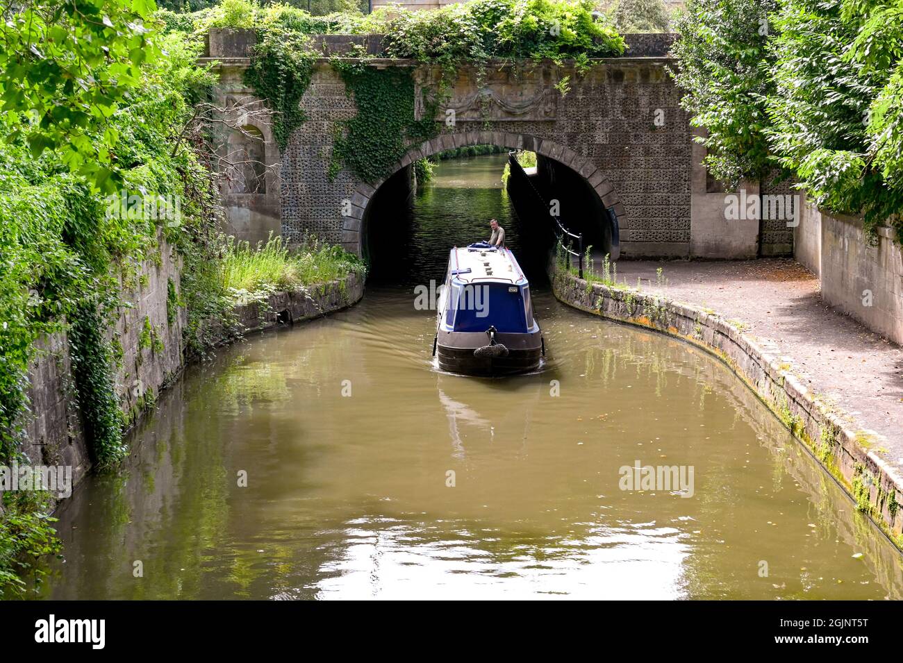 Bath, England - August 2021: Person steering a narrow boat along the ...