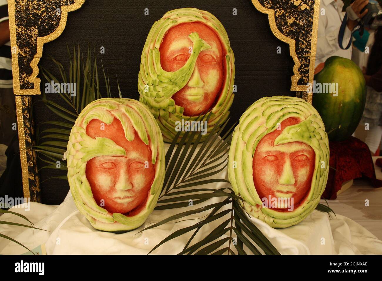 Hand carving of faces in a watermellon hi-res stock photography and ...