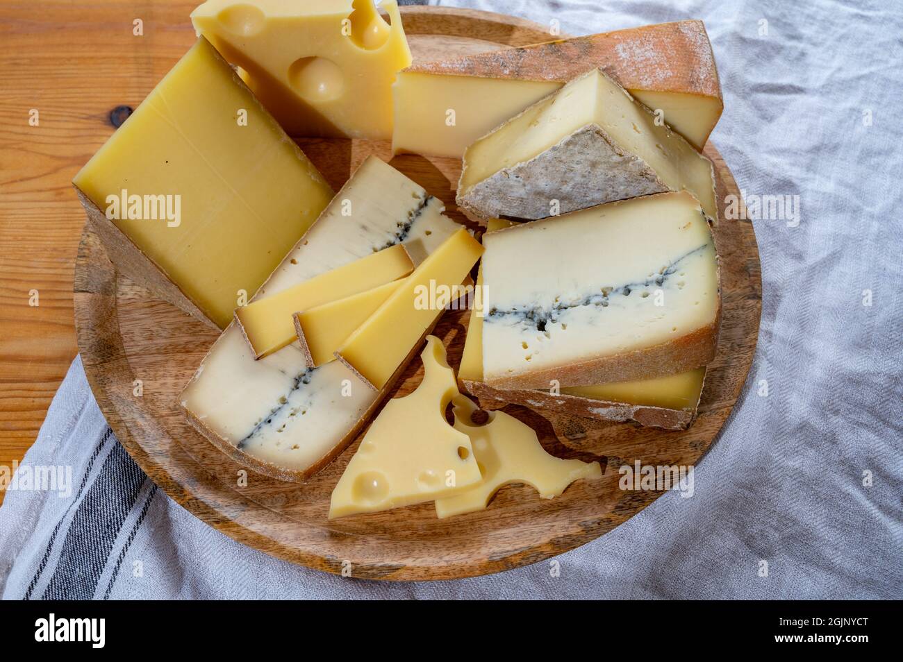 Cheese collection, wooden board with French cheeses comte, beaufort ...