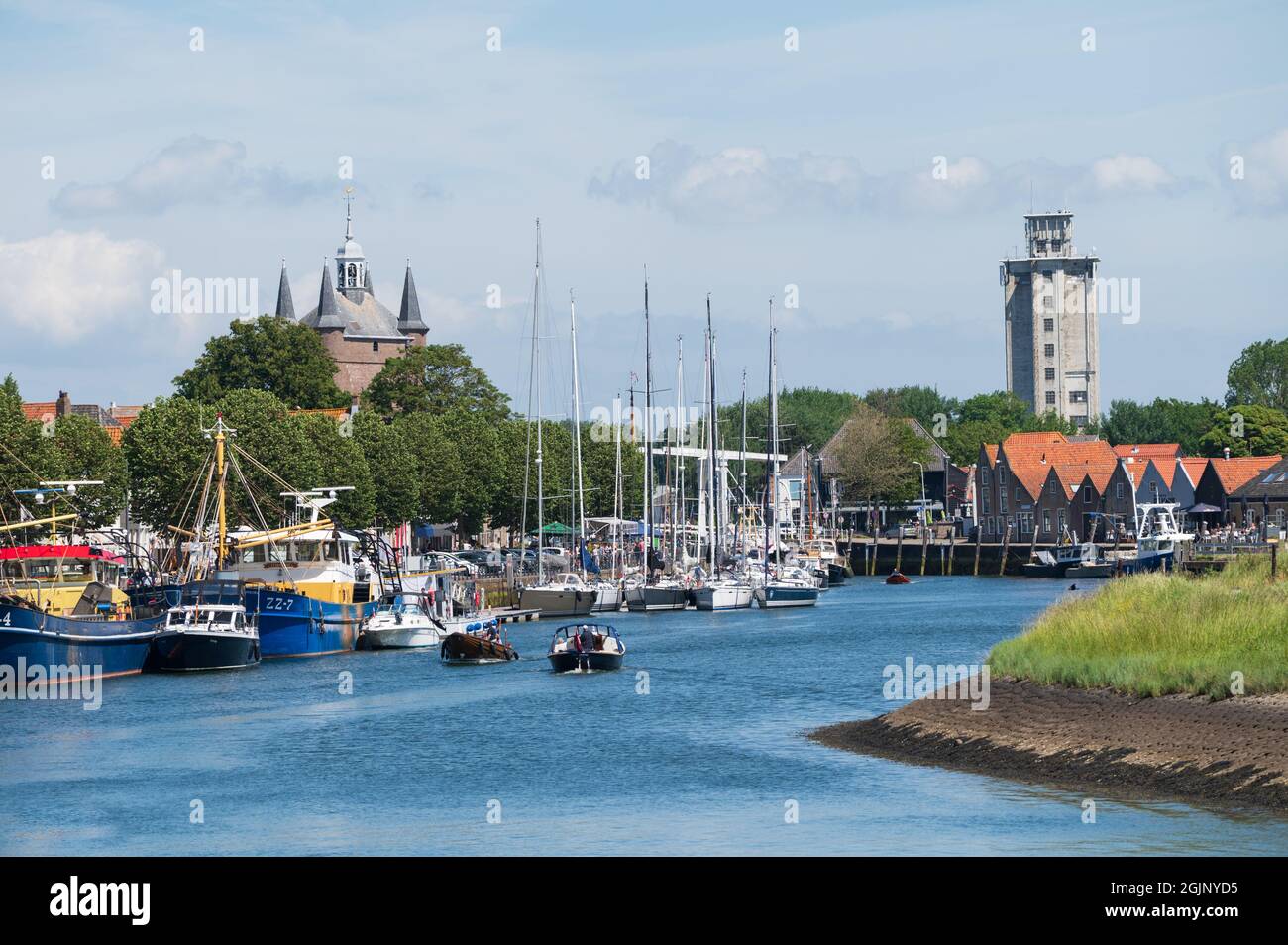 Walking in old Dutch town Zierikzee with fisherman boats, old small ...