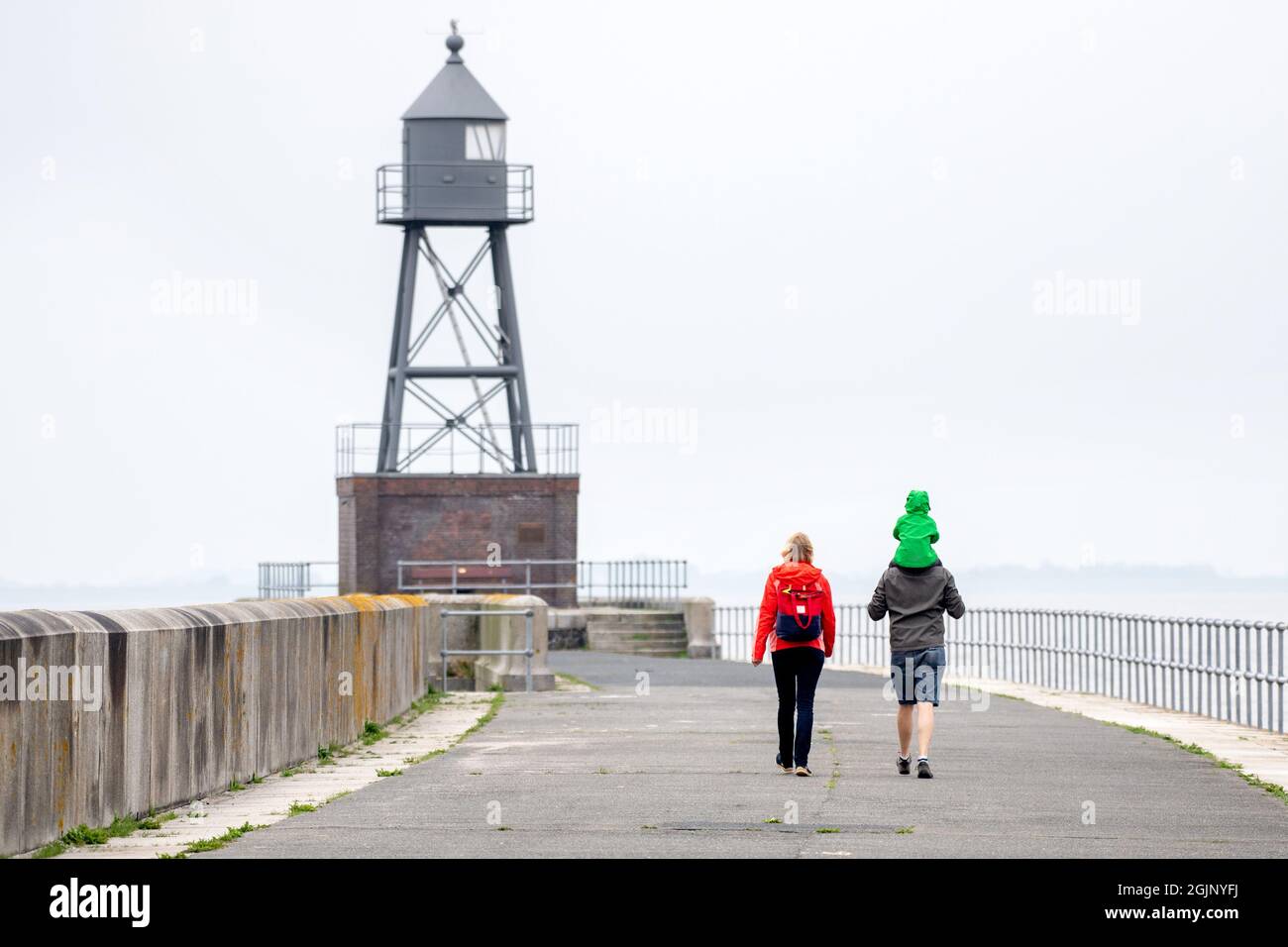Wilhelmshaven, Germany. 11th Sep, 2021. A family walks along a pier in ...