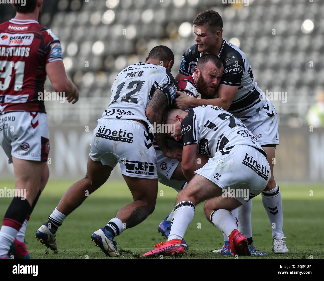 Hull FC players tackle Jake Bibby (22) of Wigan Warriors Stock Photo ...