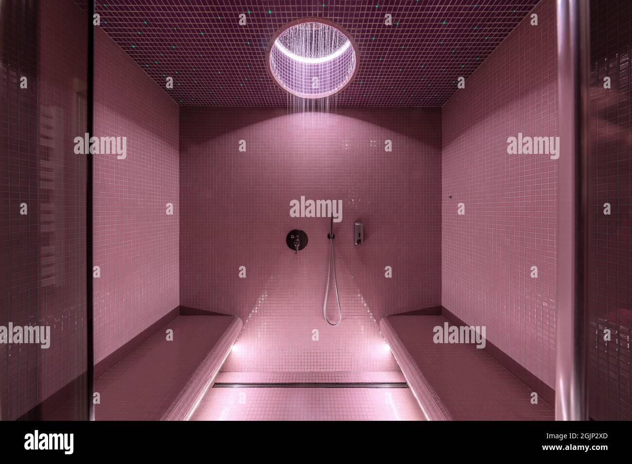 Modern steam sauna with small tiles, shower and a seat. Hamam ...