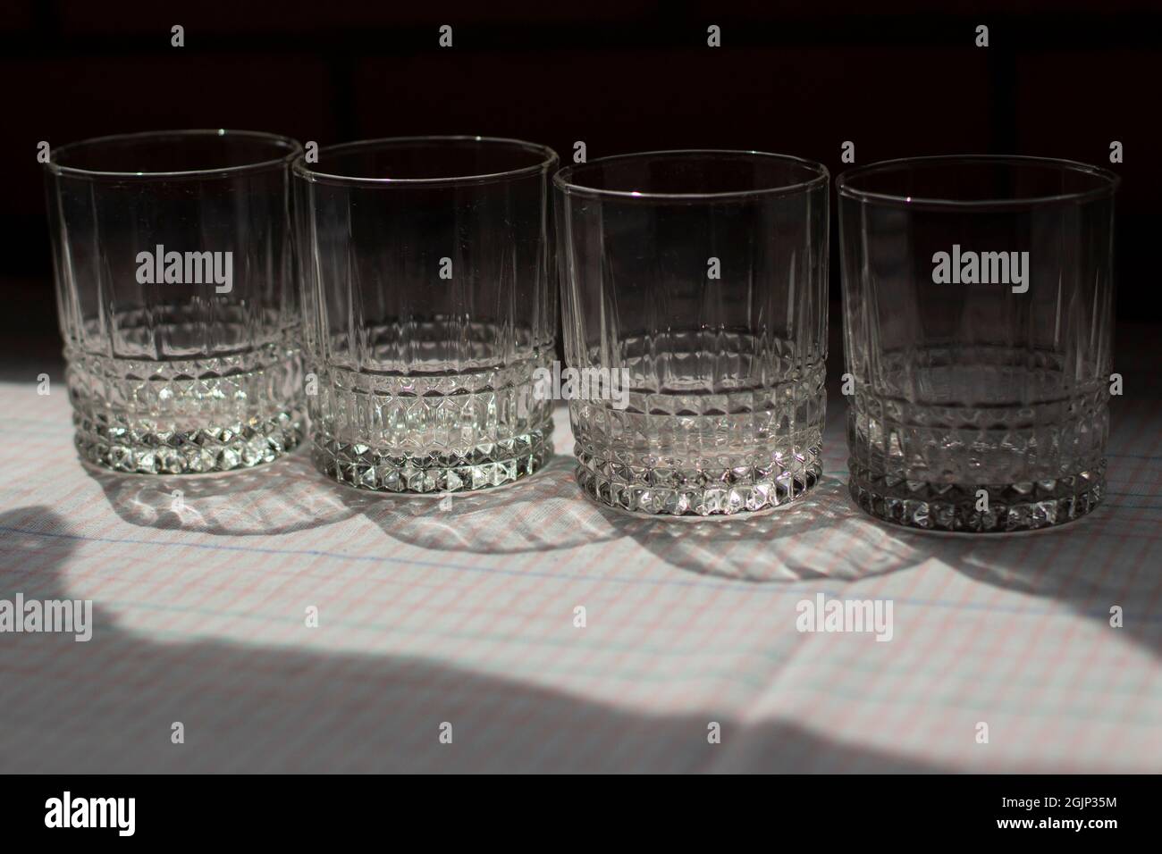 Glass beakers. Transparent glass on the table. Dishes in the kitchen ...