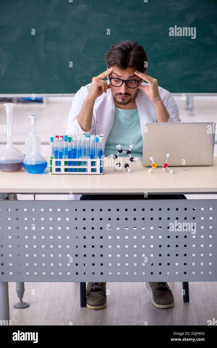 Young chemist in front of blackboard Stock Photo - Alamy