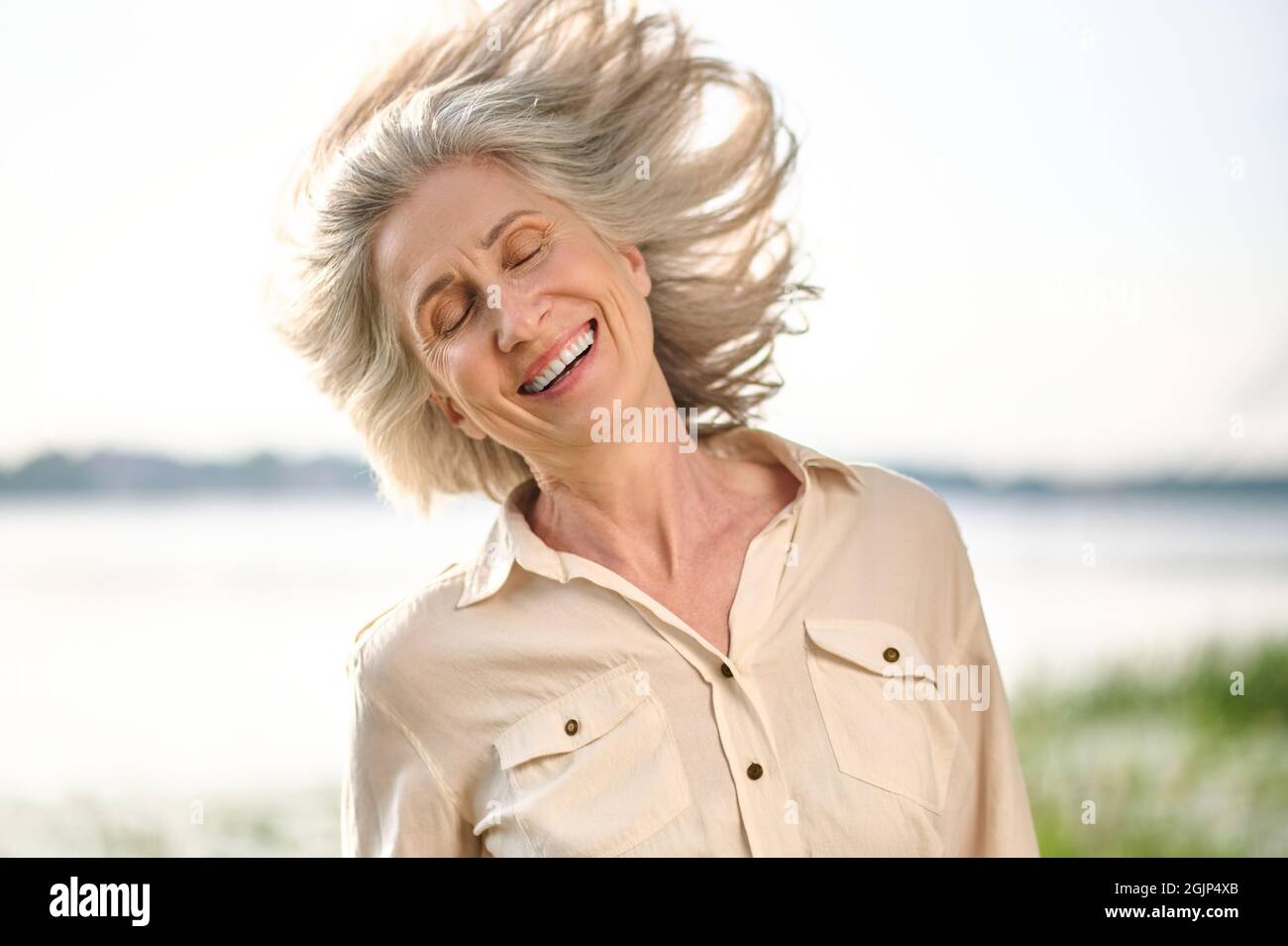 Woman with closed eyes and wind in her hair Stock Photo - Alamy