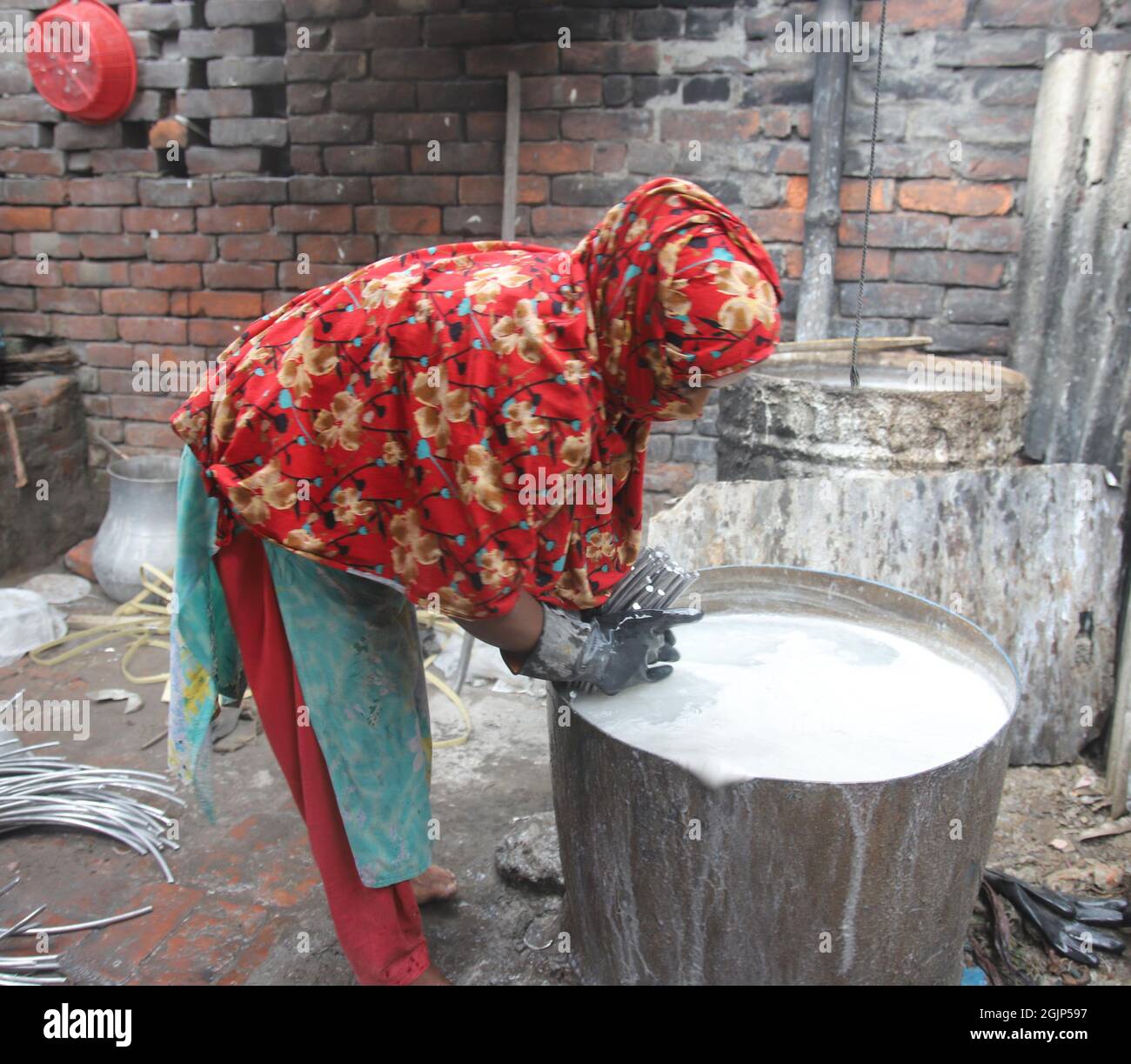 Non Exclusive: DHAKA CITY, BANGLADESH, SEPTEMBER 9: Workers beat water ...