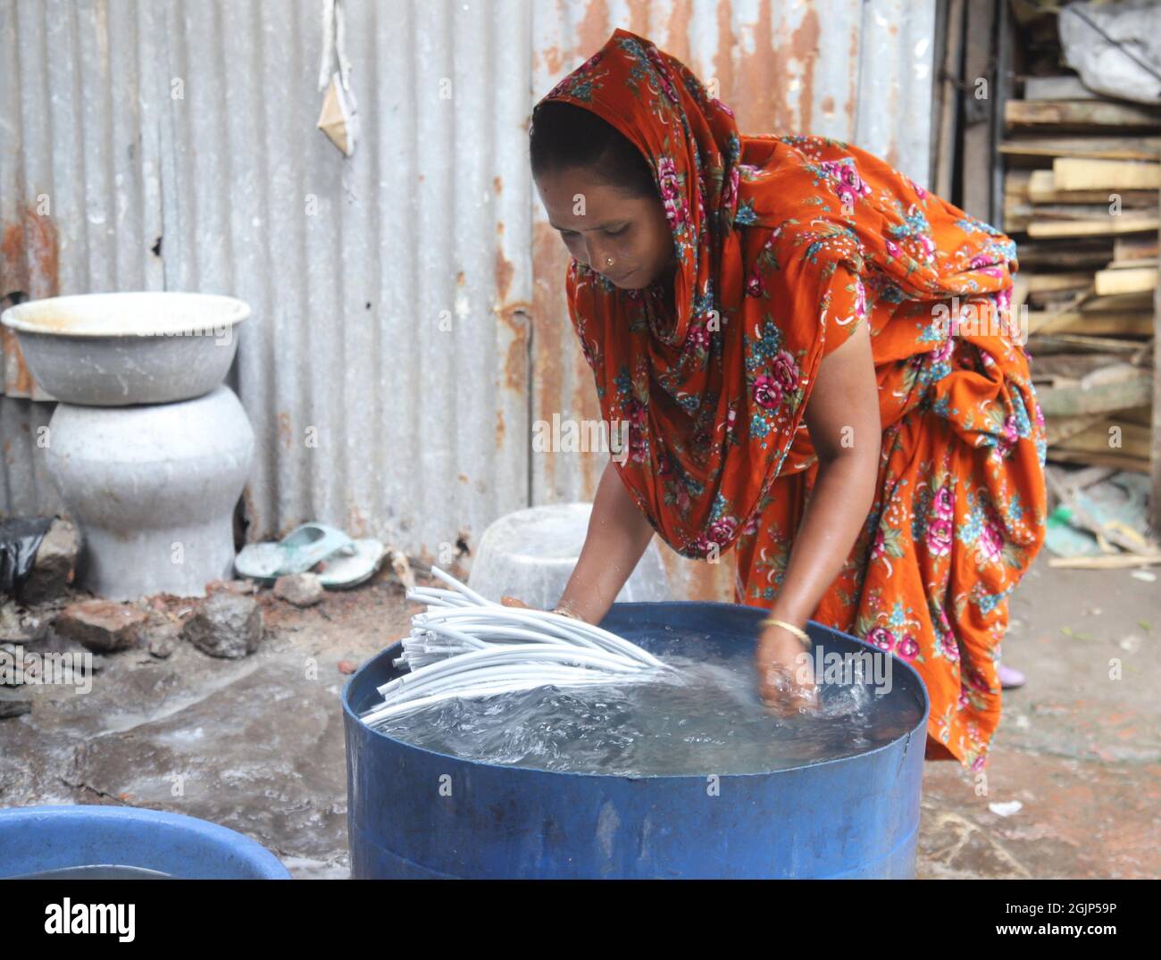 Non Exclusive: DHAKA CITY, BANGLADESH, SEPTEMBER 9: Workers beat water ...