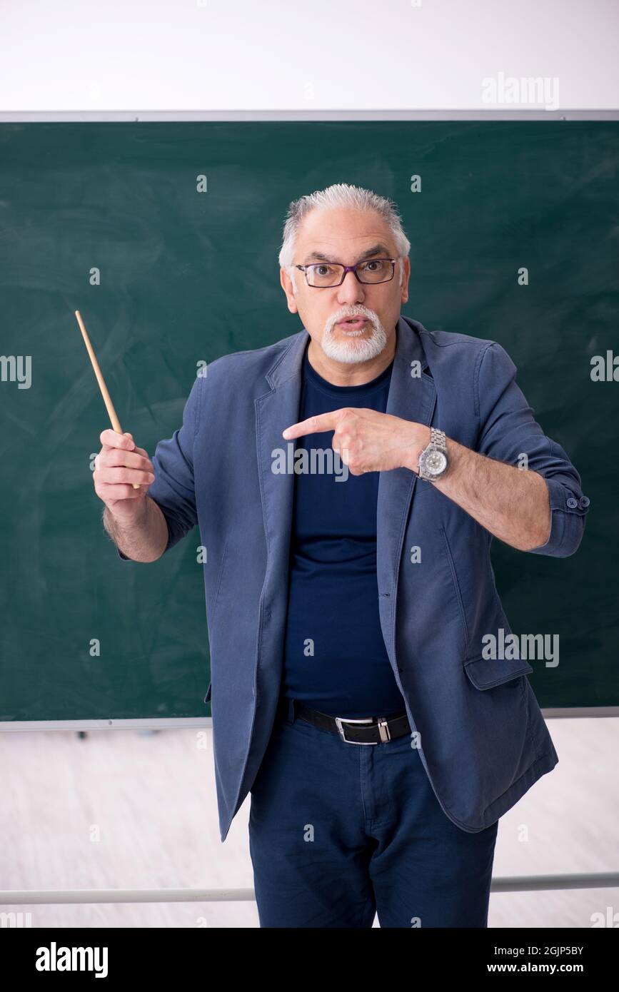 Old teacher in the classroom Stock Photo - Alamy