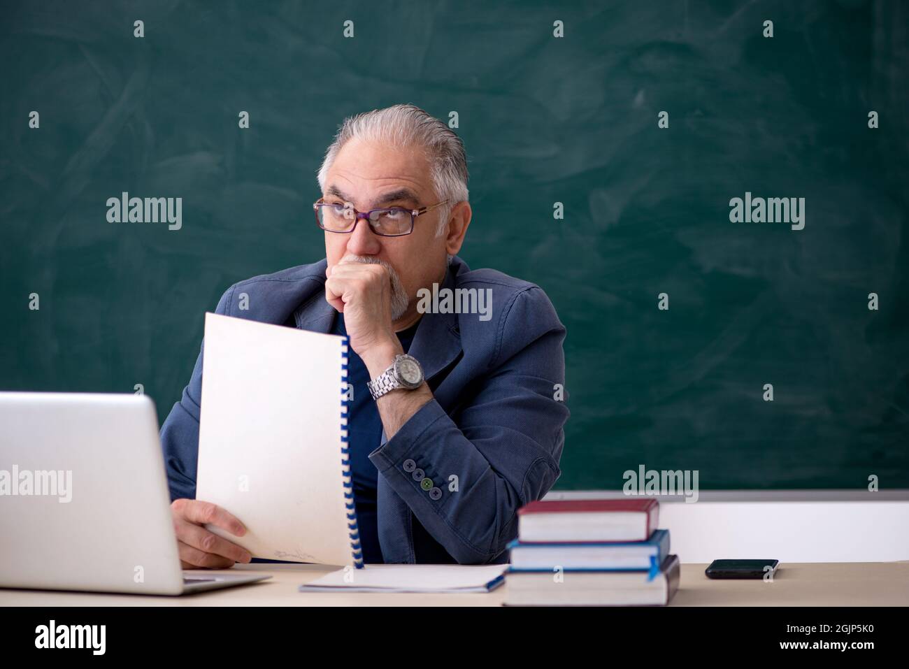 Old teacher in the classroom Stock Photo - Alamy