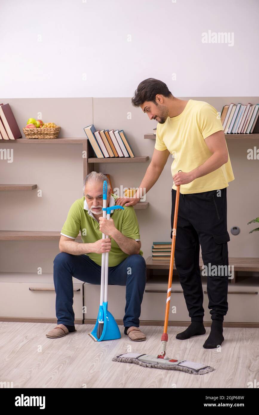 Father son sweeping floor hi-res stock photography and images - Alamy