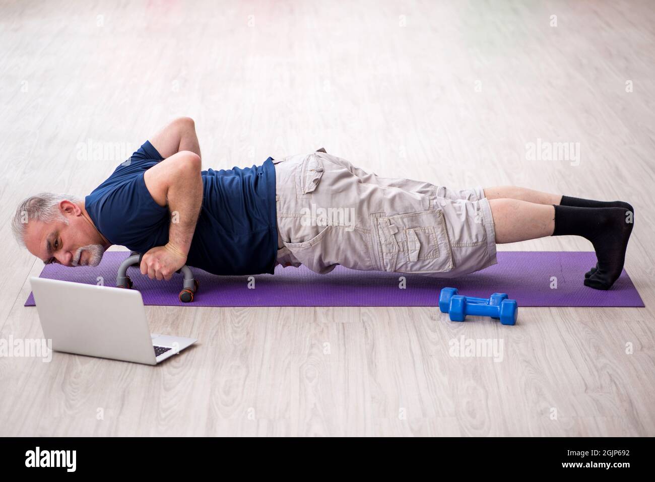 Old man doing sport exercises at home Stock Photo - Alamy