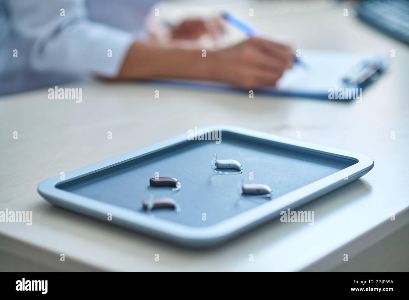 Hearing aid tray on otolaryngologists desk Stock Photo - Alamy