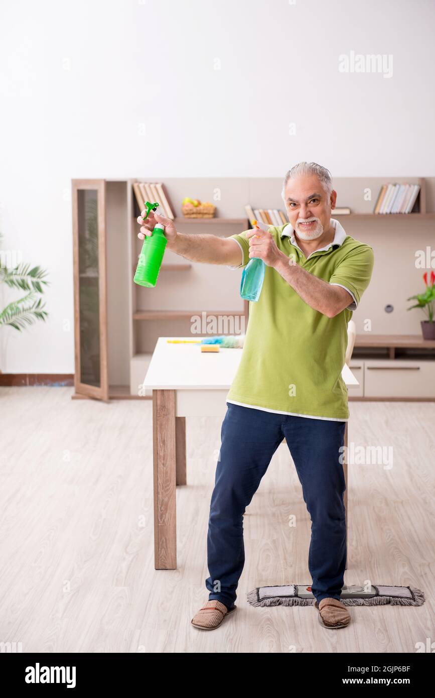 Aged man cleaning the house Stock Photo - Alamy