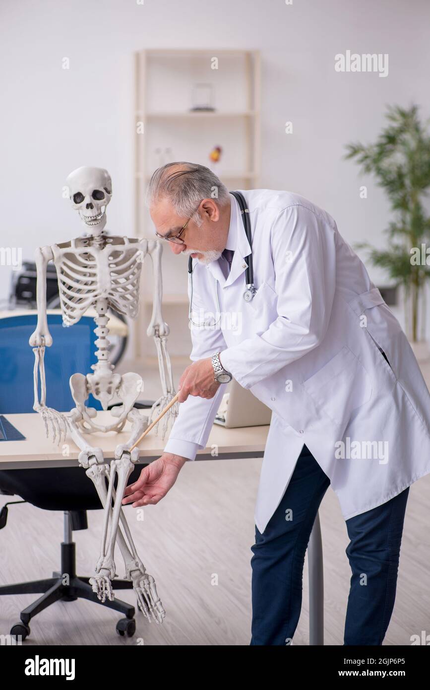 Old doctor demonstrating human skeleton Stock Photo - Alamy