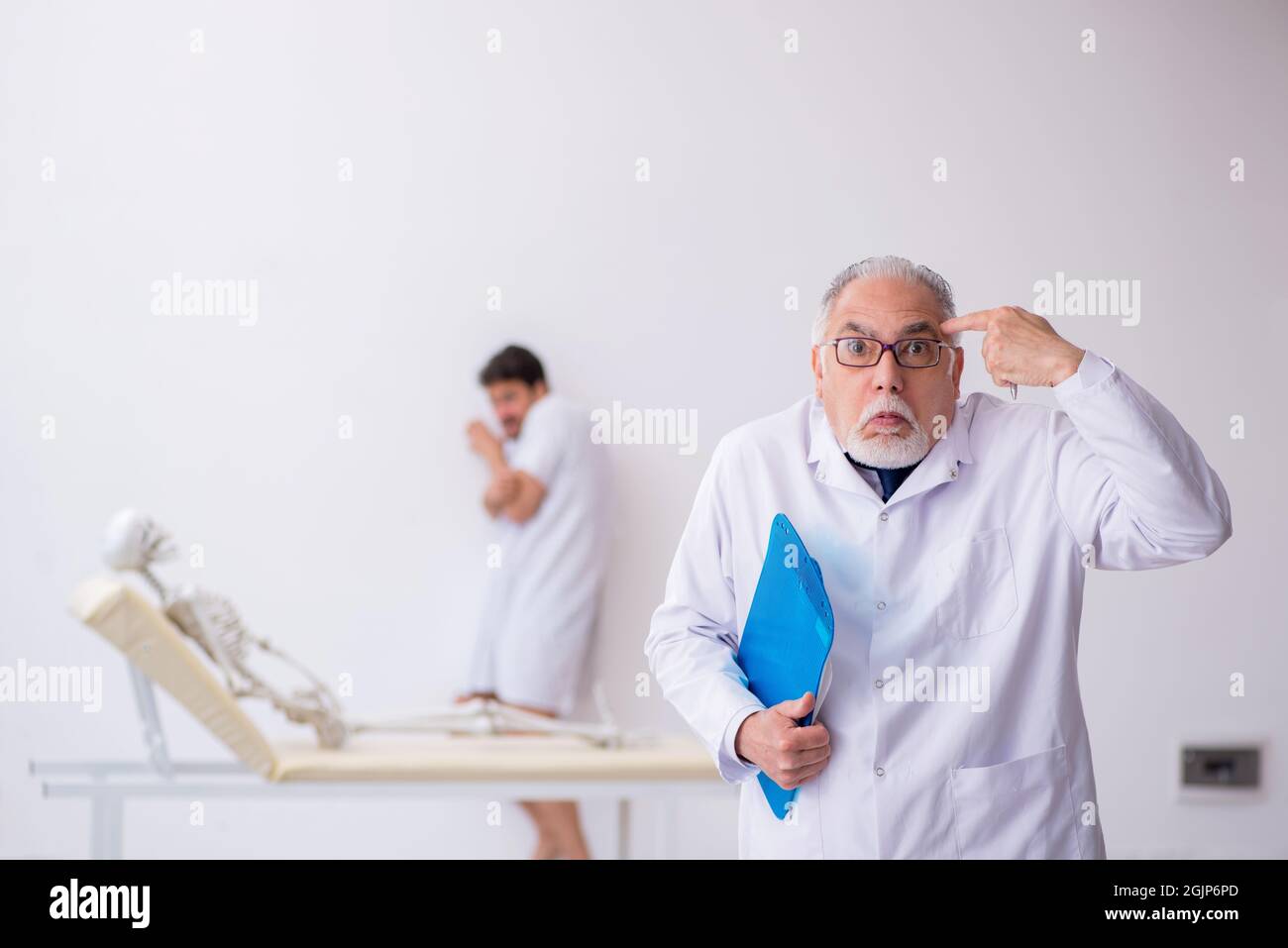 Old doctor psychiatrist examining young male patient Stock Photo - Alamy