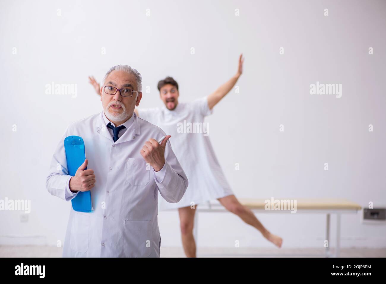 Old doctor psychiatrist examining young male patient Stock Photo - Alamy