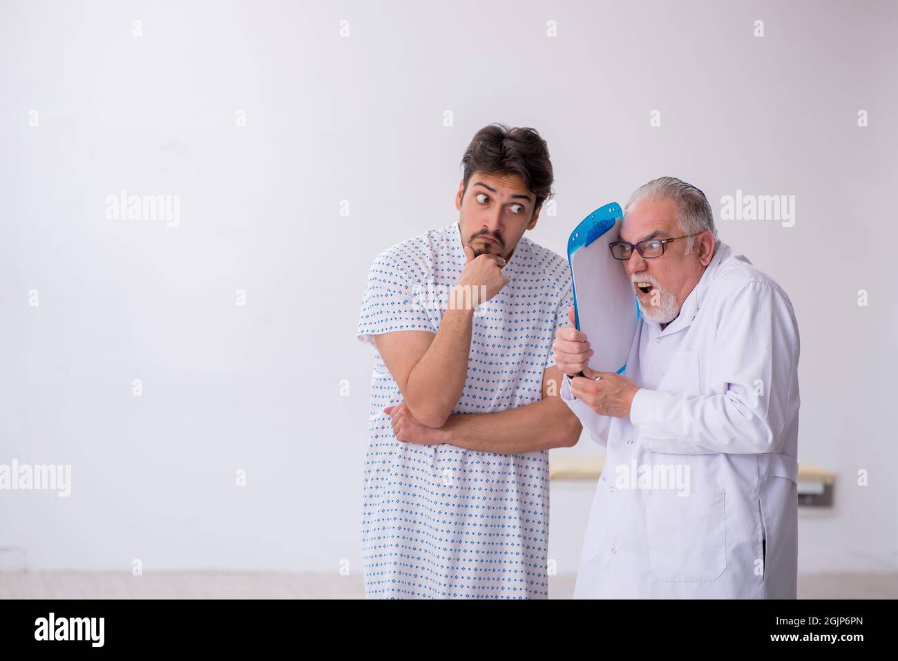 Old doctor psychiatrist examining young male patient Stock Photo - Alamy
