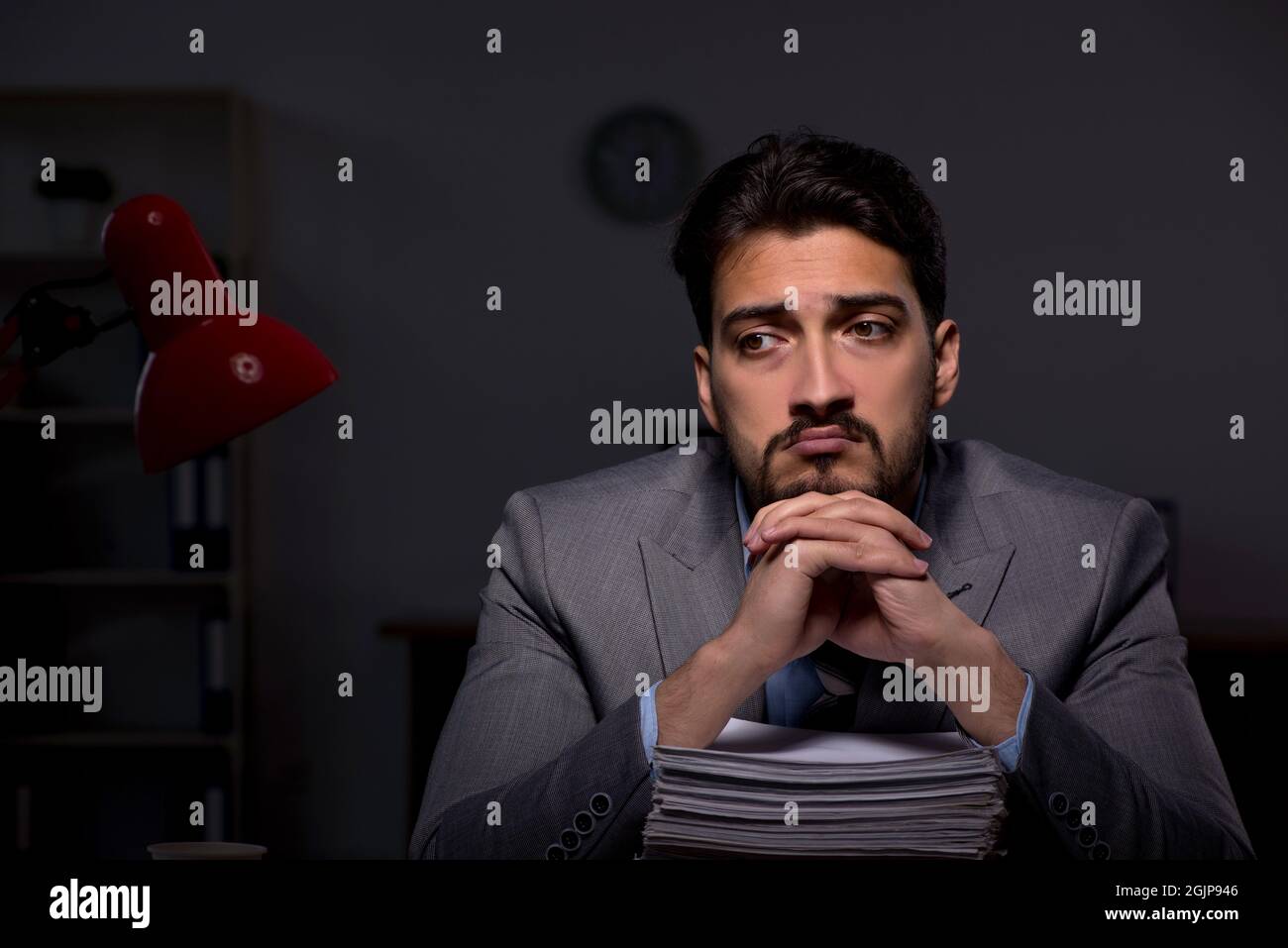 Young employee working late in the office Stock Photo - Alamy