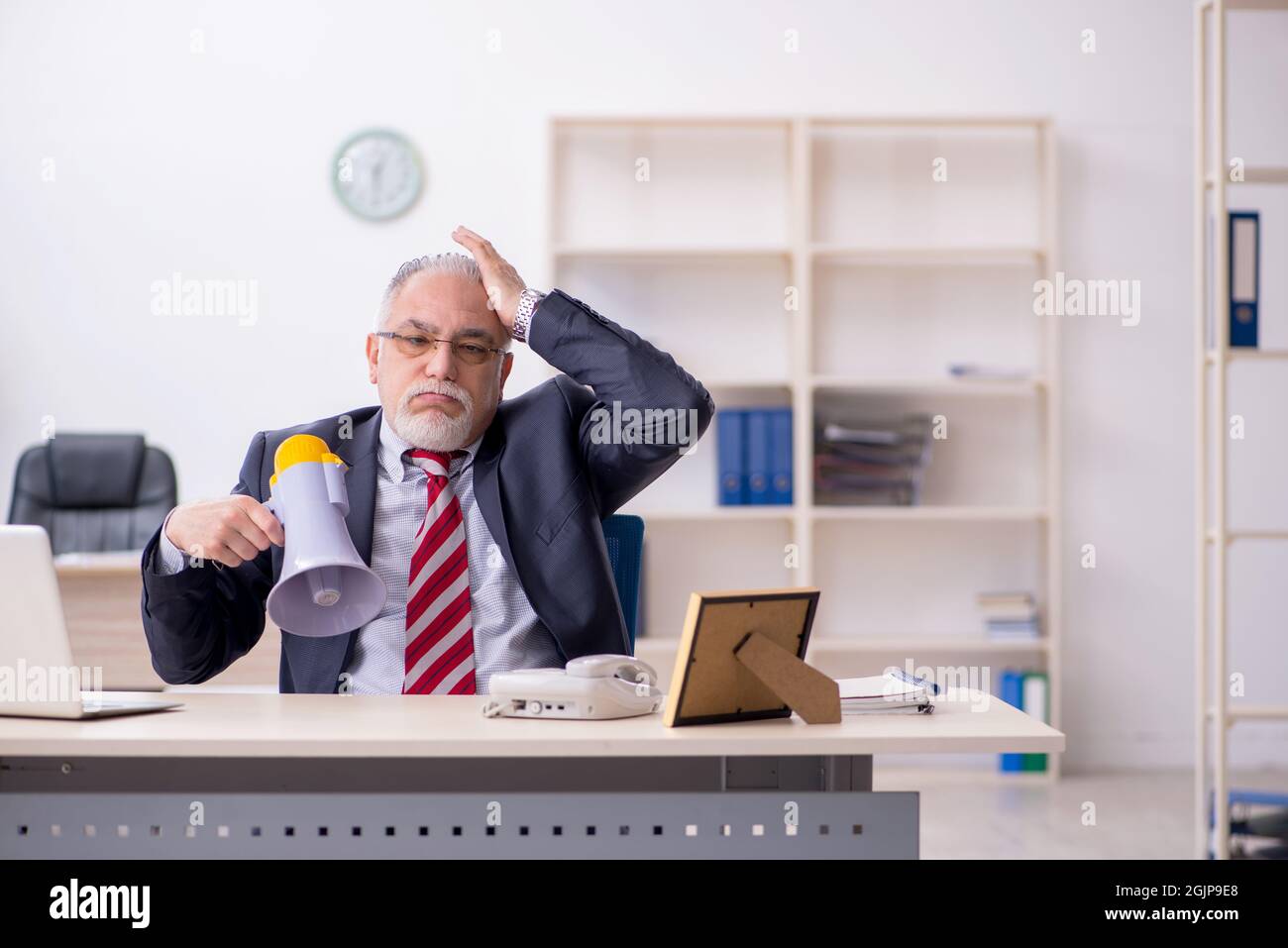 Angry boss holding megaphone in the office Stock Photo - Alamy