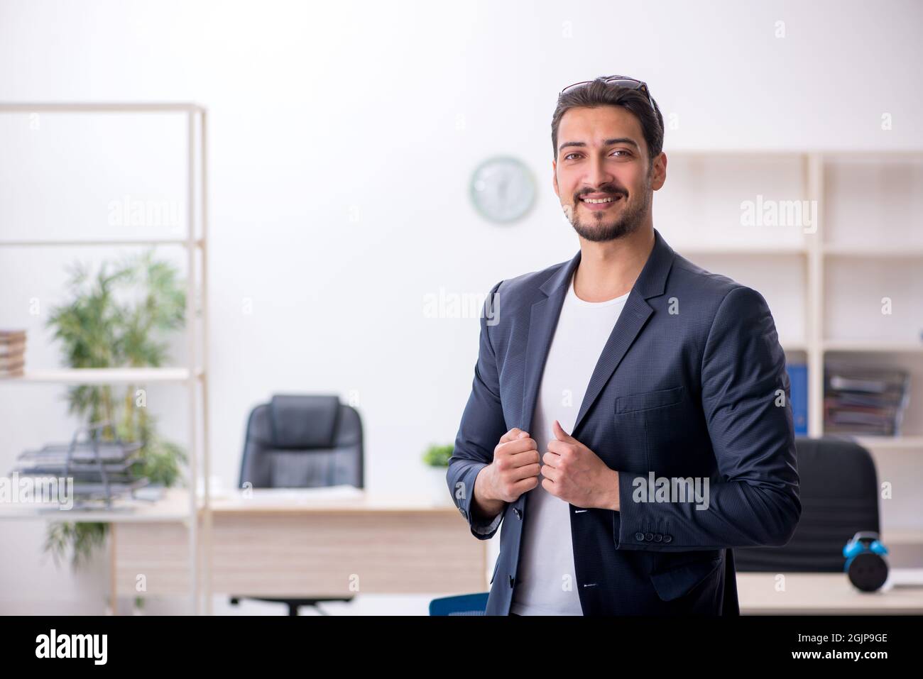 Young male employee working in the office Stock Photo - Alamy