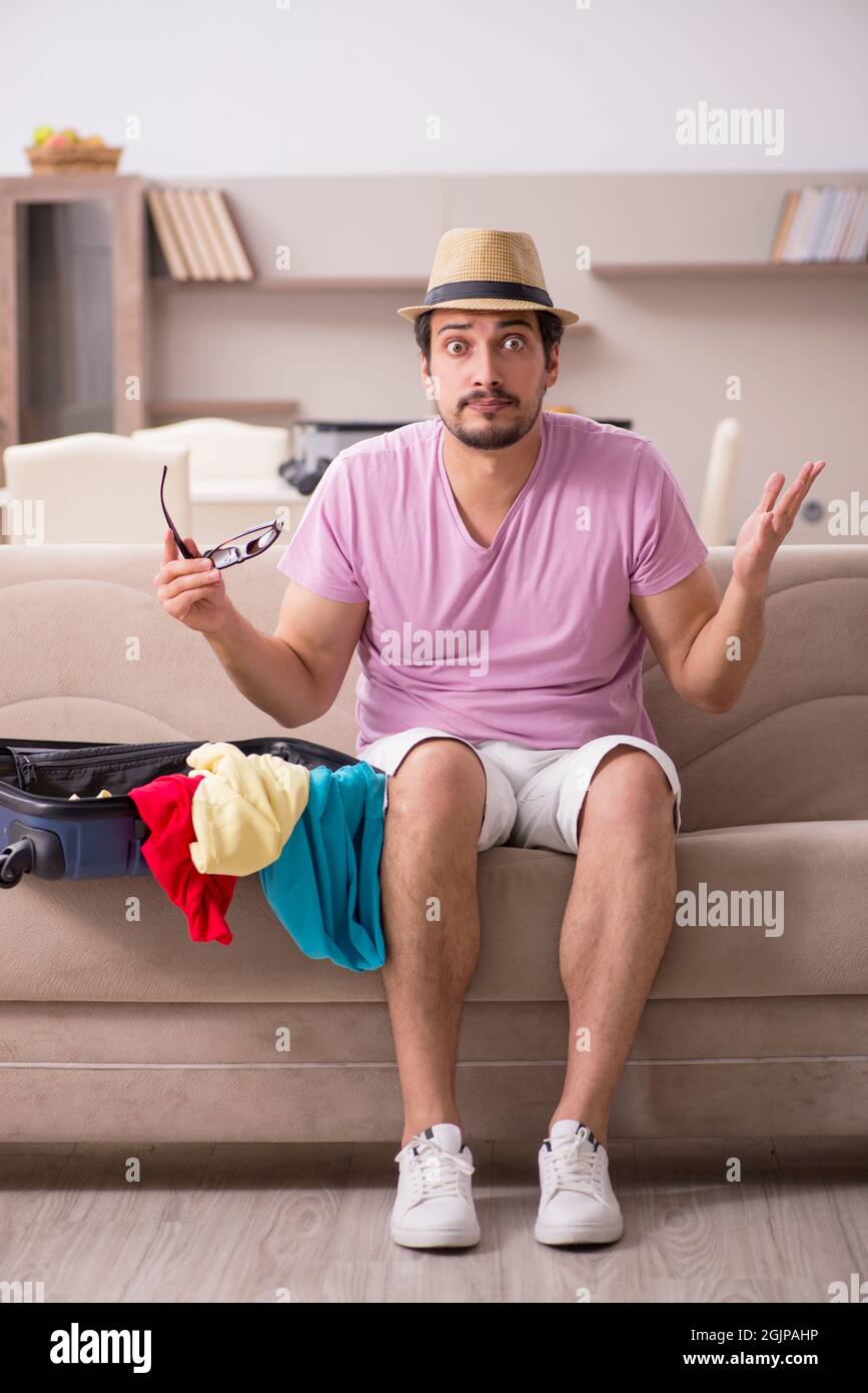 Young male student preparing for trip at home Stock Photo - Alamy