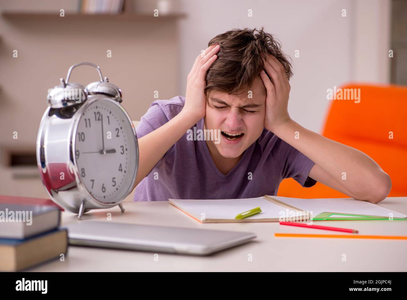 Male pupil preparing for exams at home Stock Photo - Alamy