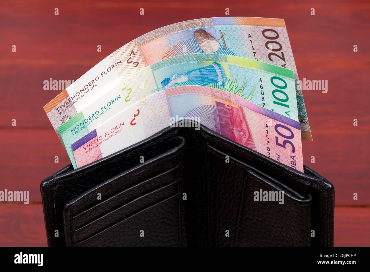 Aruban money - florin in the black wallet Stock Photo - Alamy