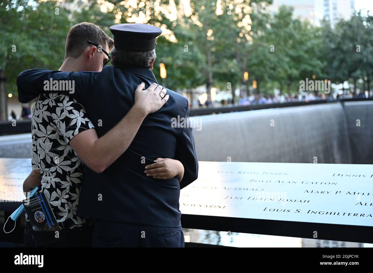 New York, USA. 11th Sep, 2021. James Hagan of Baldwin, LI is hugged by ...