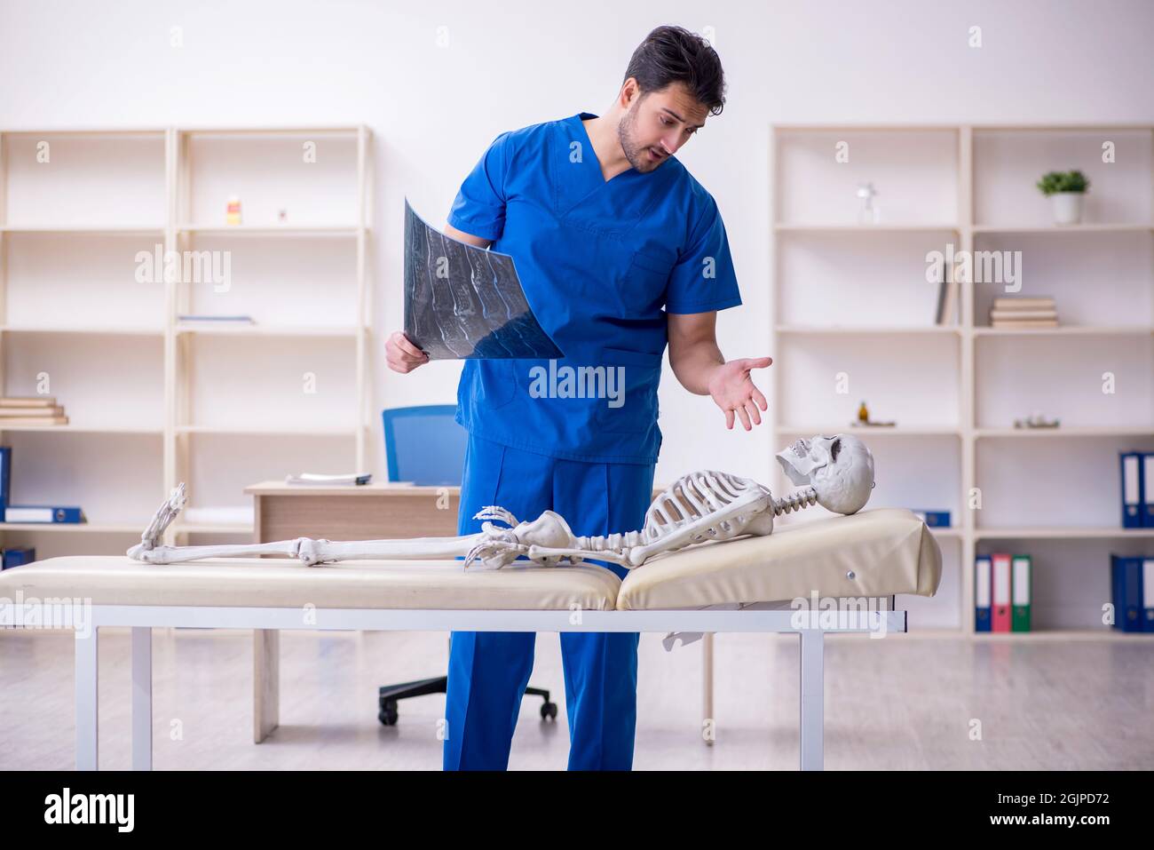 Young doctor radiologist examining skeleton patient Stock Photo - Alamy