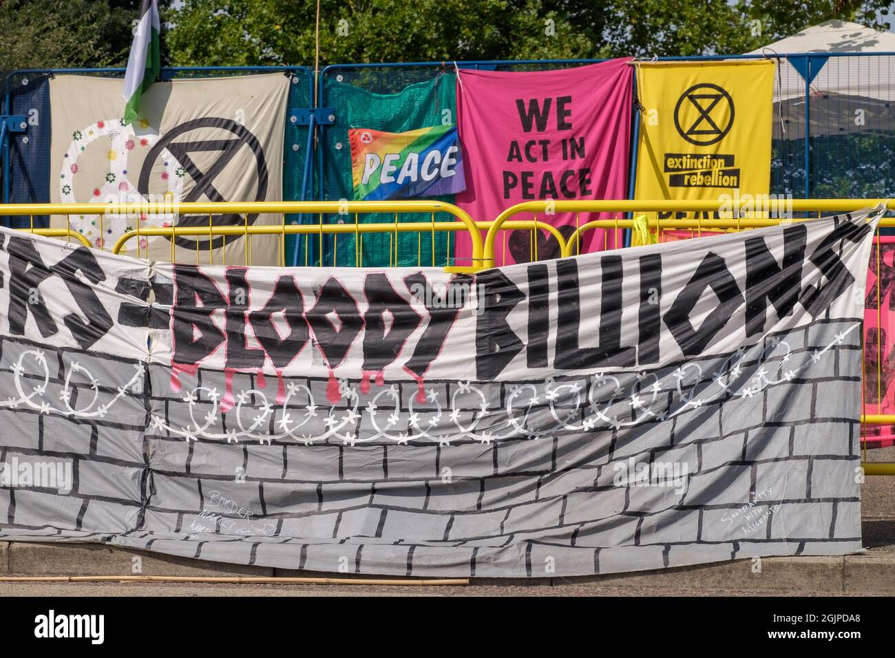 London, UK. 21st Sep 2021. Banners by the roadside at the protest camp ...