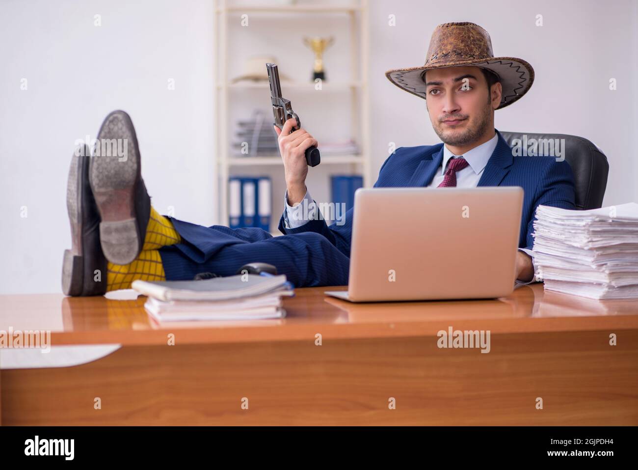 Young cowboy employee working at workplace Stock Photo - Alamy