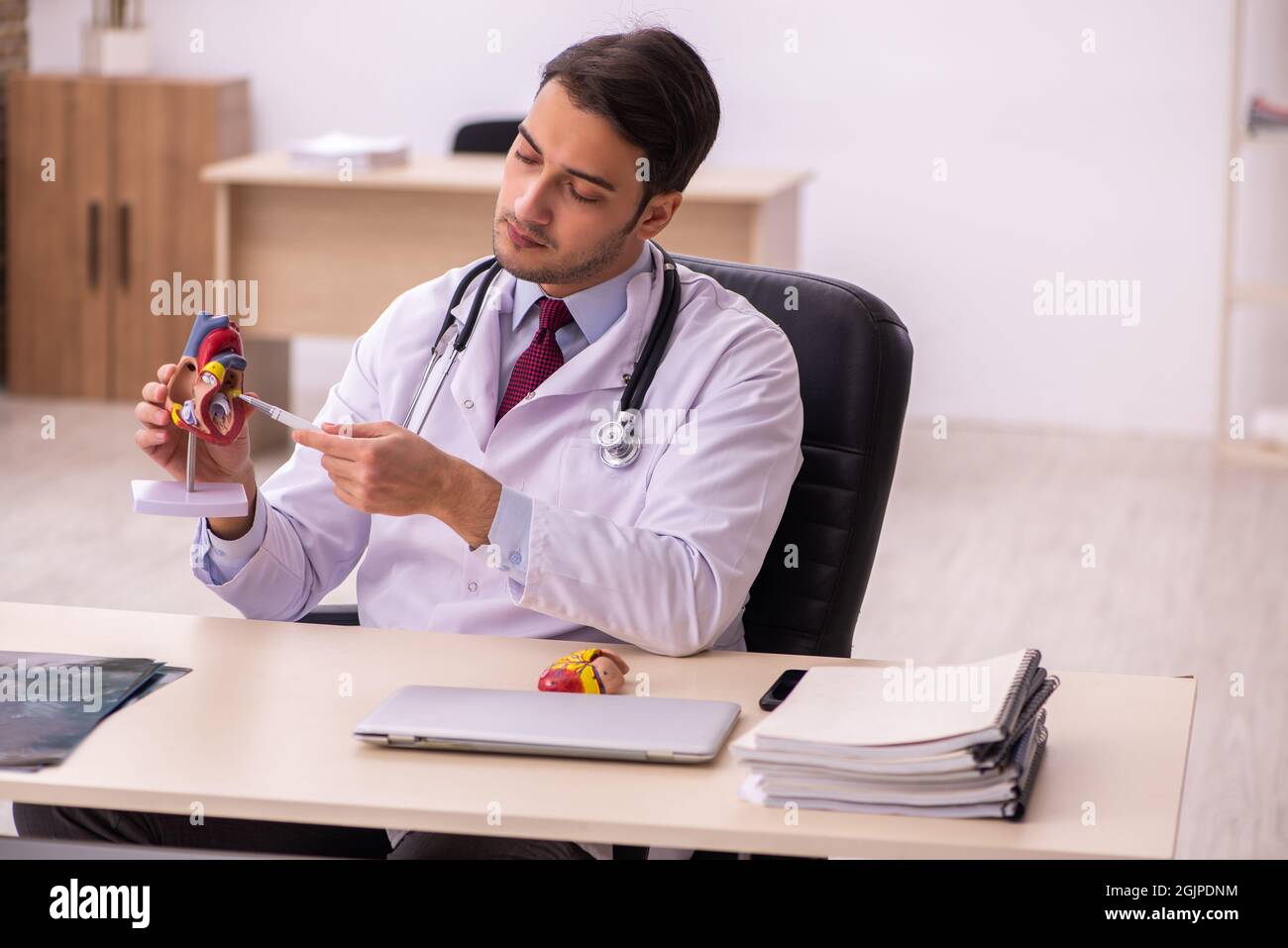 Young male doctor cardiologist working at the hospital Stock Photo - Alamy