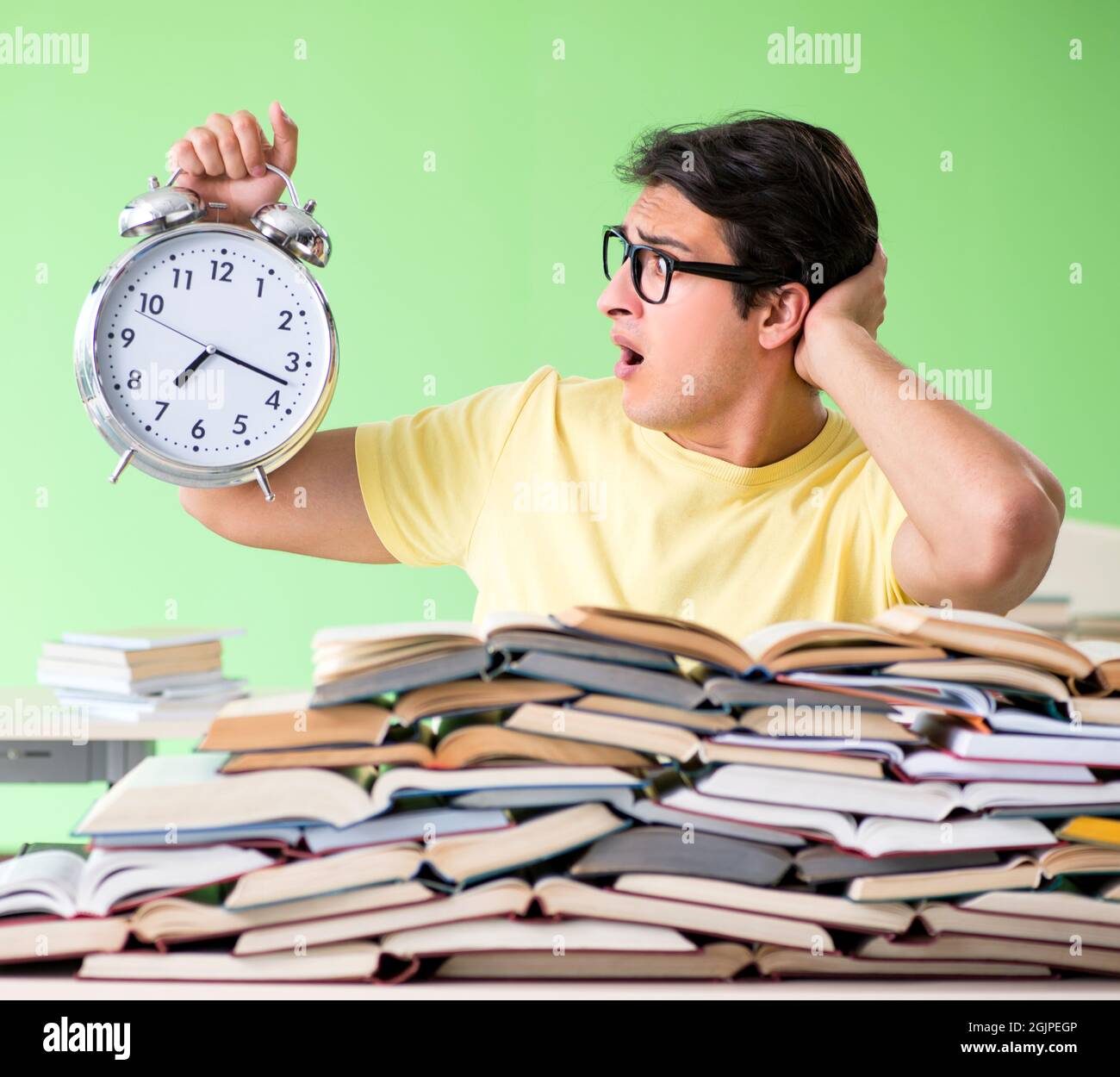 Student with too many books to read before the exam Stock Photo - Alamy