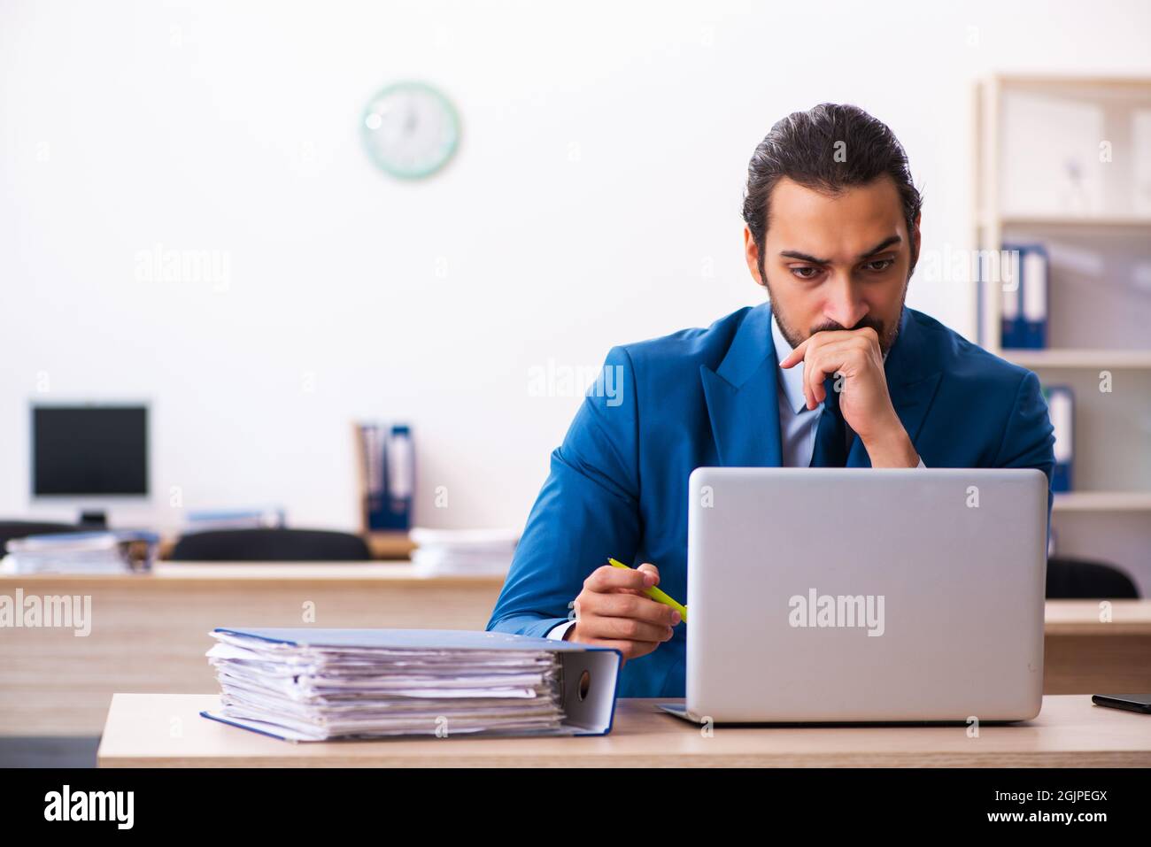 Young employee and too many work in the office Stock Photo - Alamy