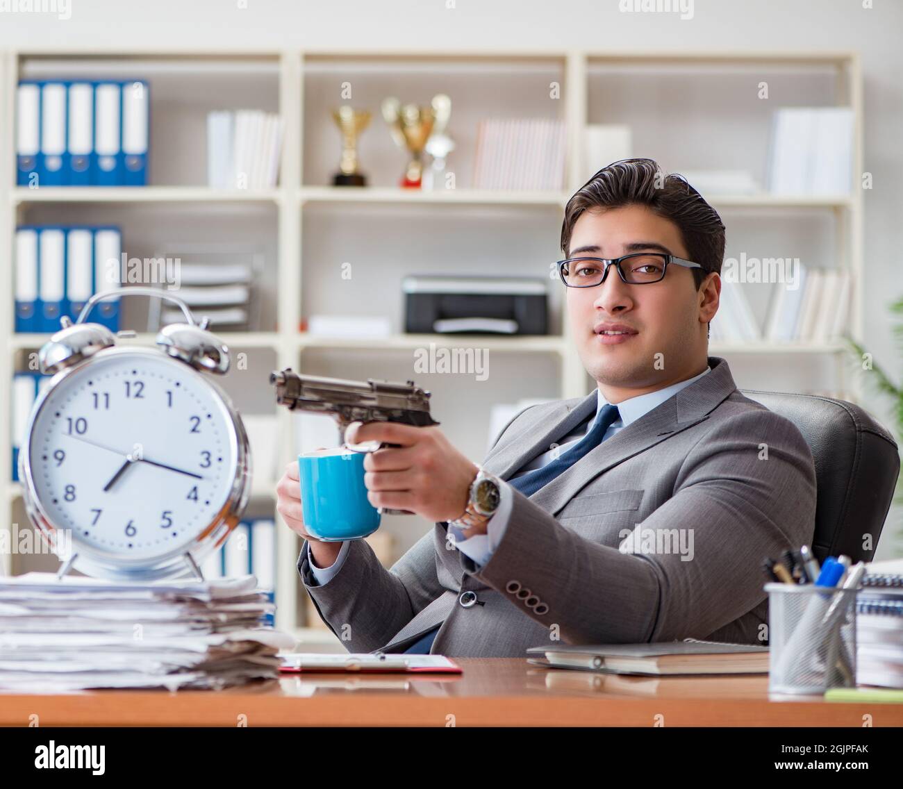 The young businessman in time management concept Stock Photo - Alamy