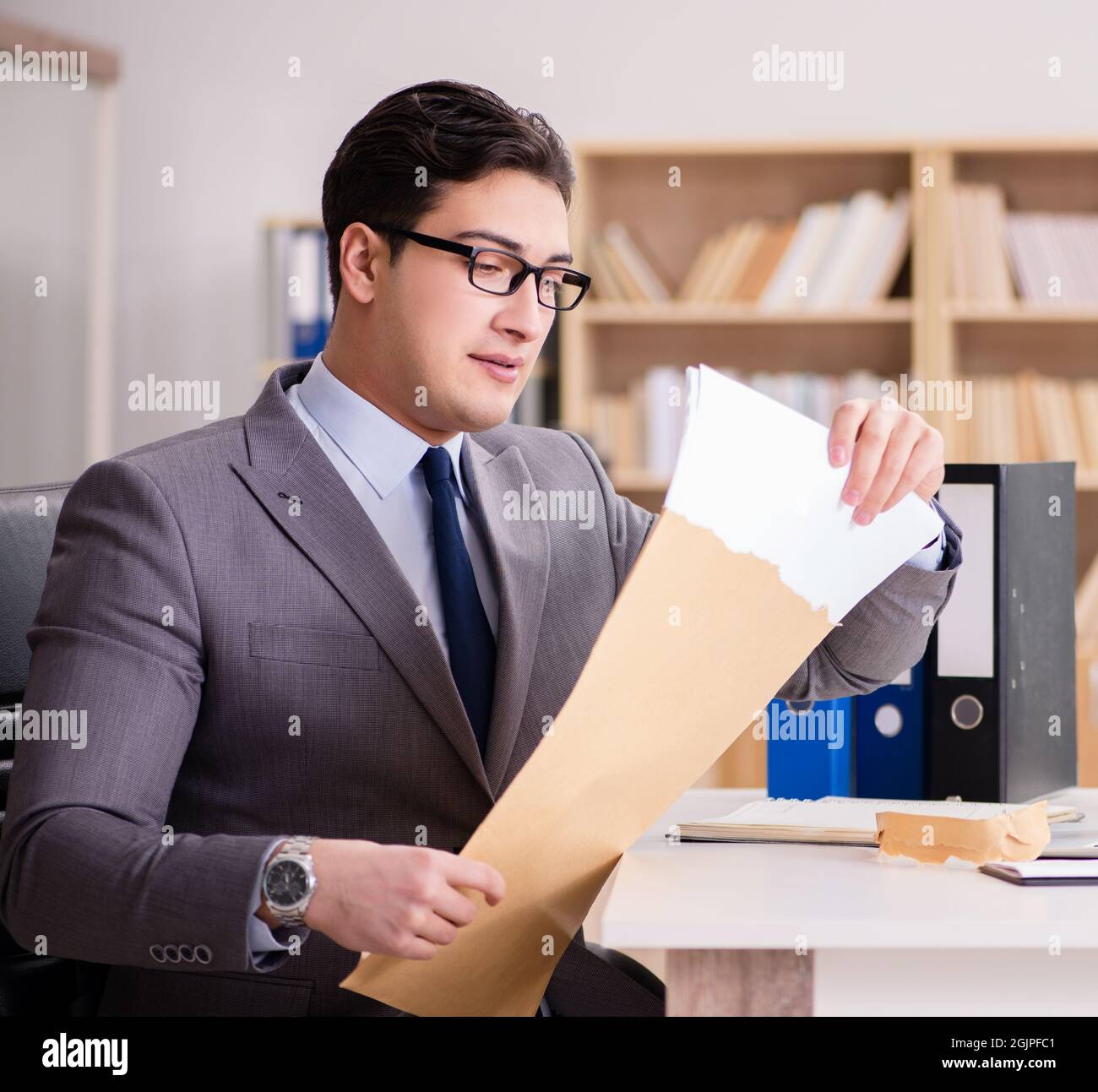 The businessman receiving letter in the office Stock Photo - Alamy