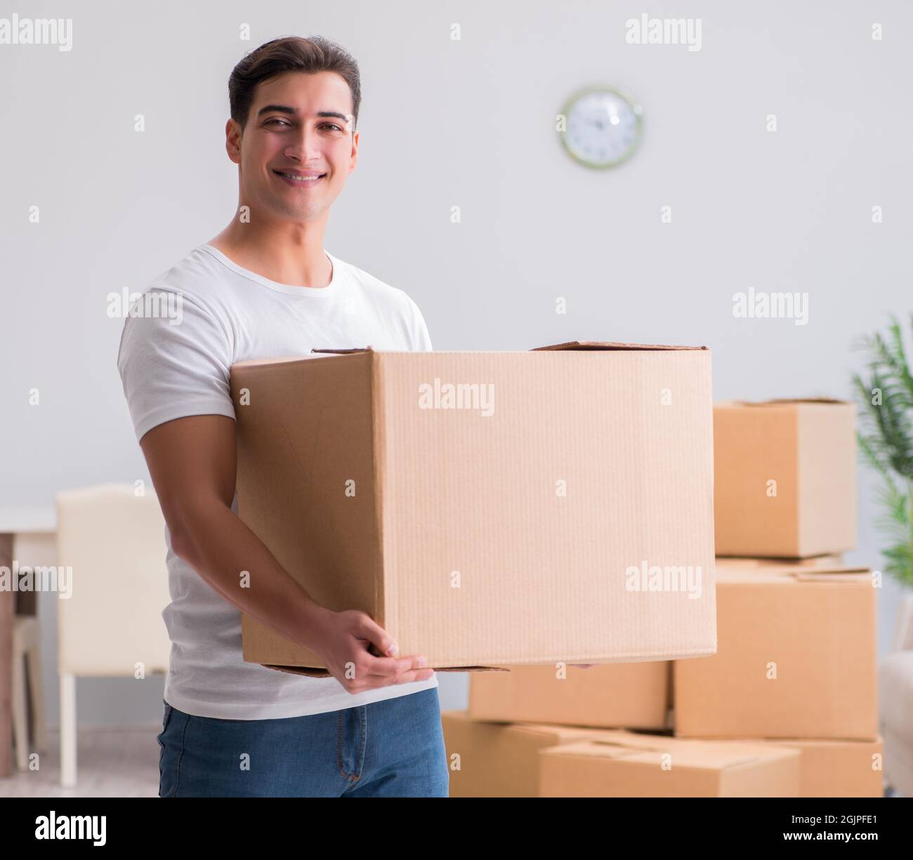 The man delivering heavy boxes at home Stock Photo - Alamy