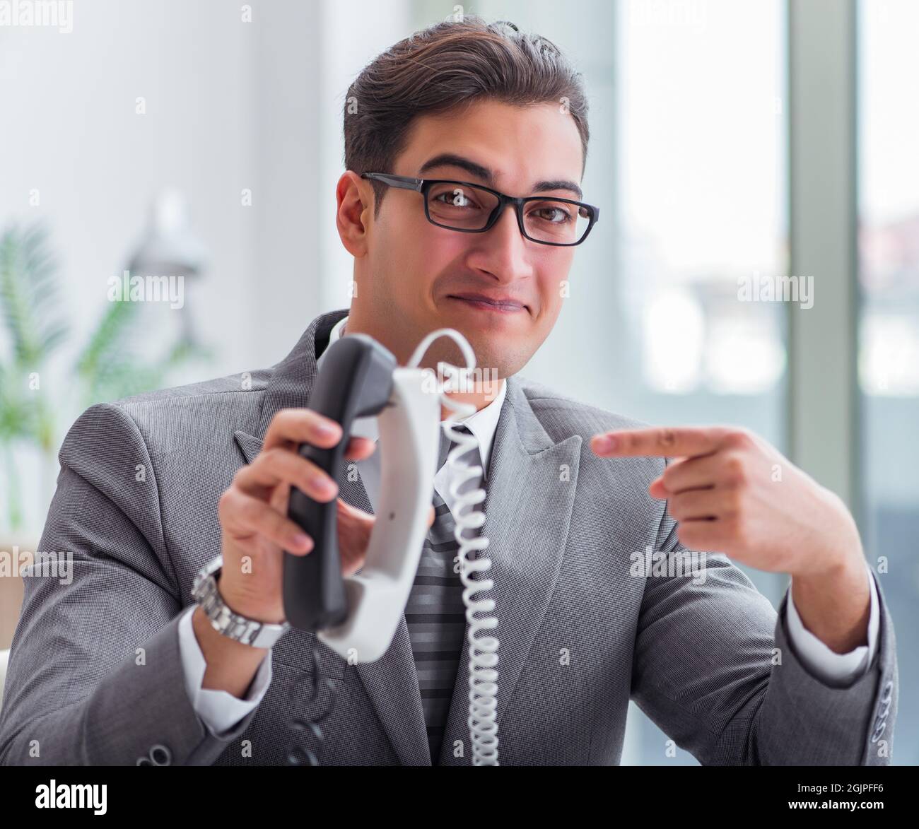 The angry helpdesk operator in the office Stock Photo - Alamy