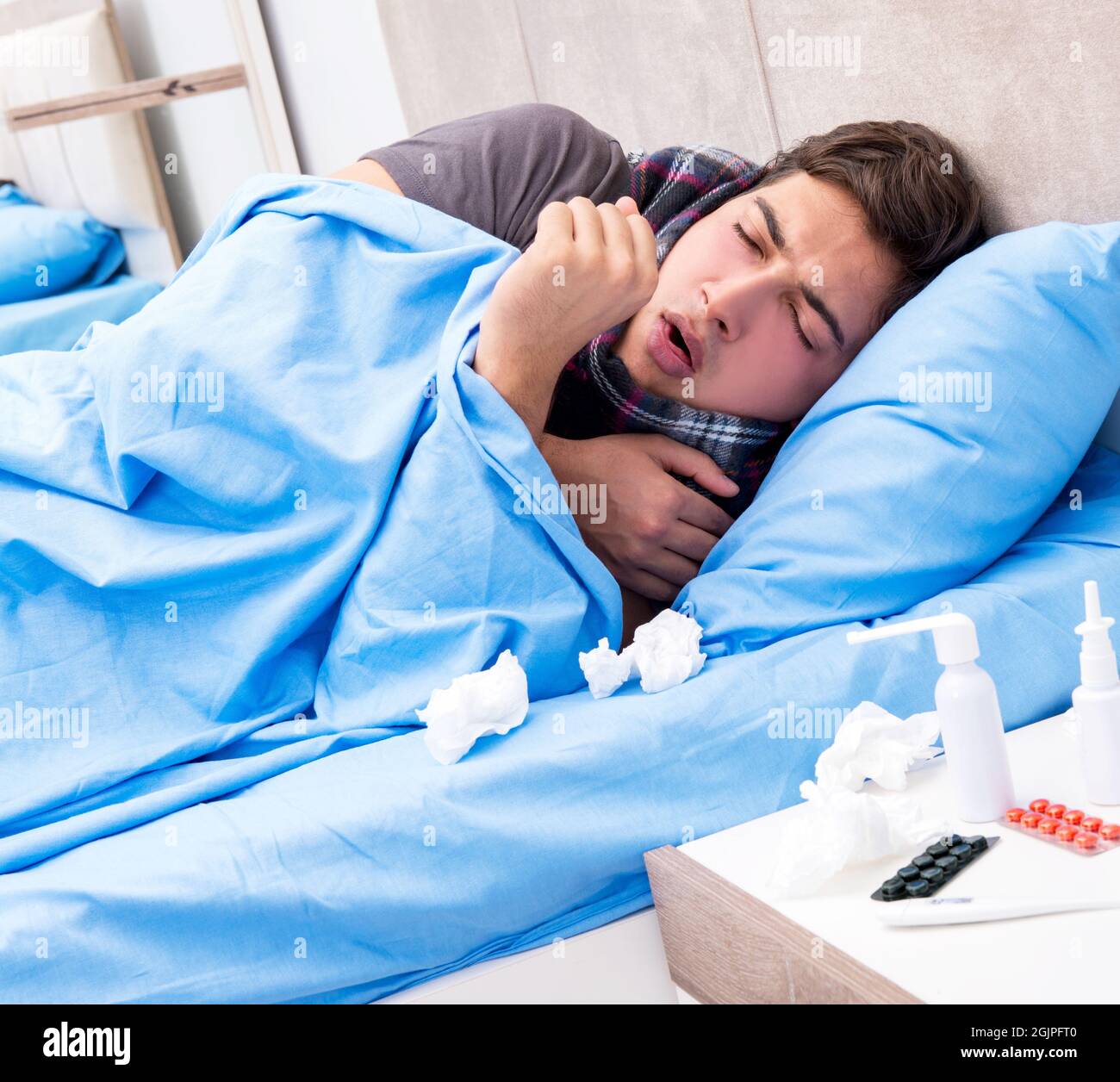 The sick man with flu lying in the bed Stock Photo - Alamy