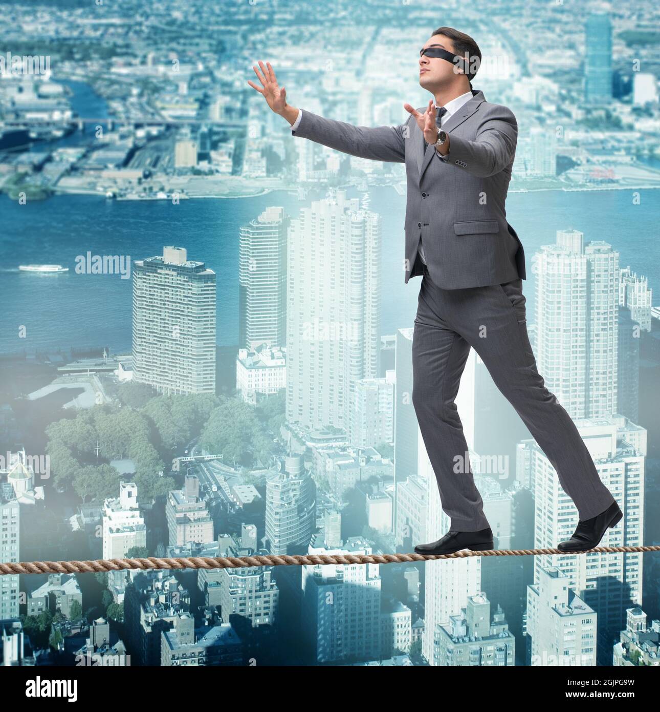 The man walking in tight rope blindfold Stock Photo - Alamy