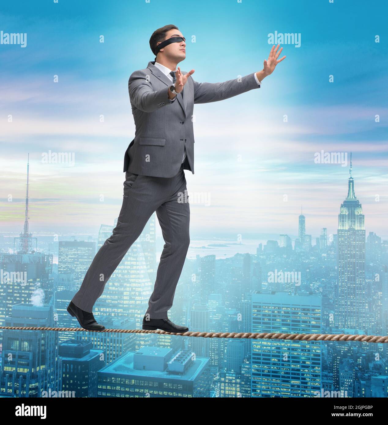 The man walking in tight rope blindfold Stock Photo - Alamy