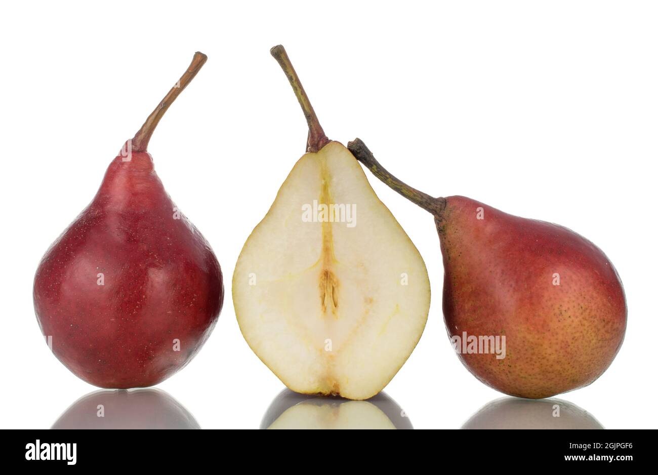 Two whole and half red pears, close-up, isolated on white Stock Photo ...