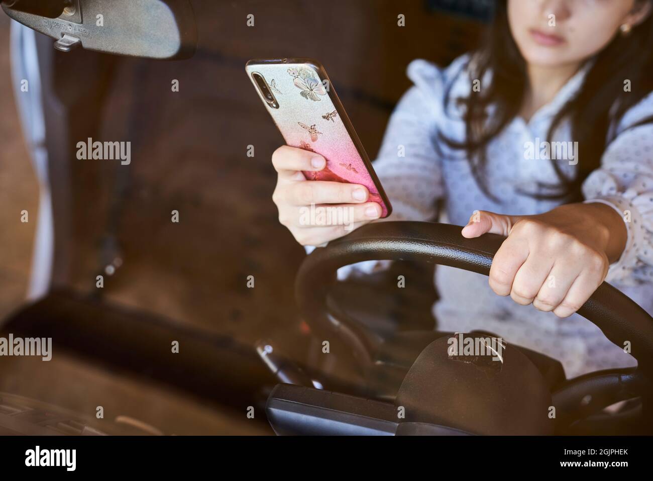 Young multiracial woman texting and driving car. Woman using cellphone ...