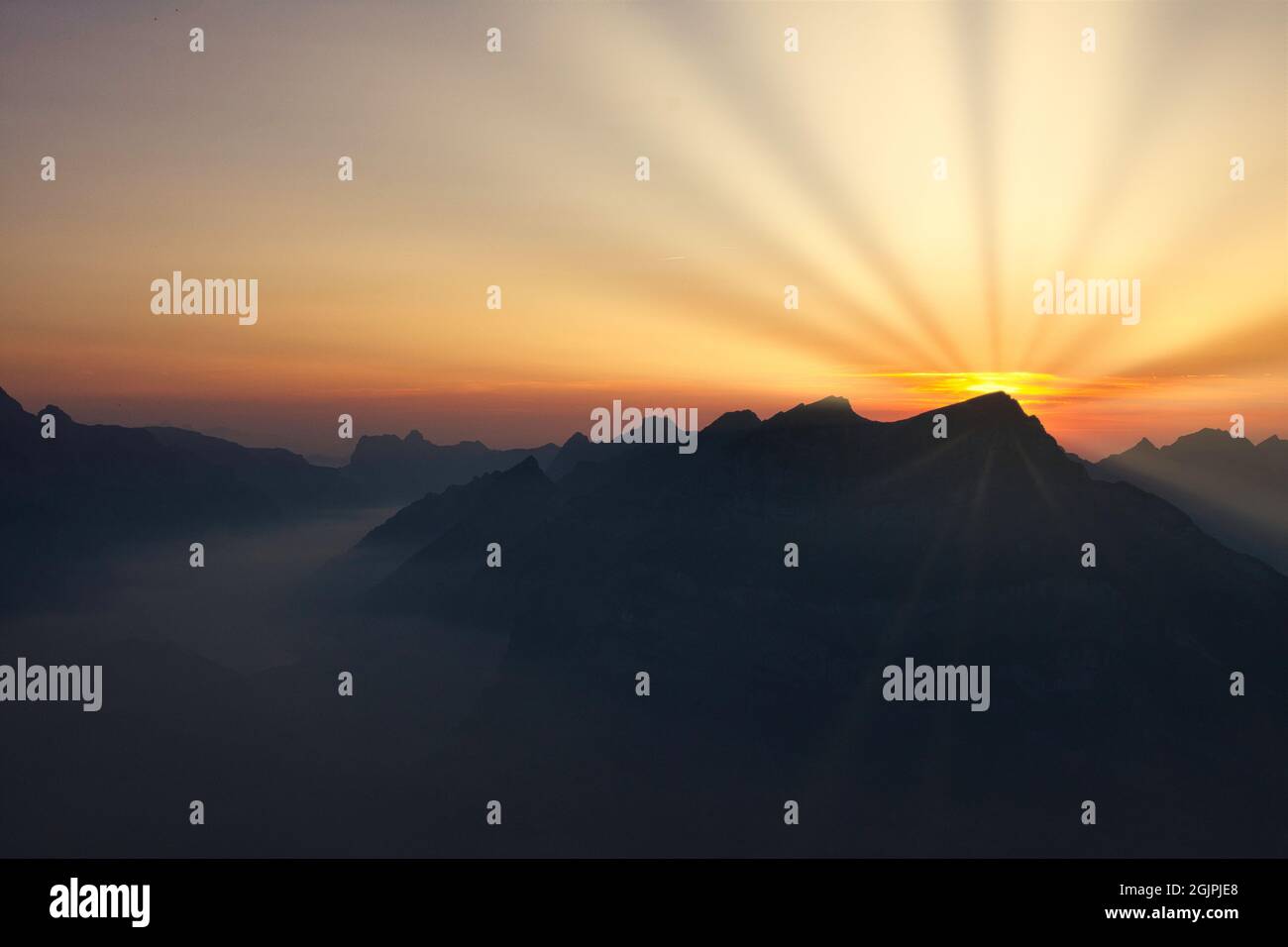 Sunbeams over swiss mountain hi-res stock photography and images - Alamy