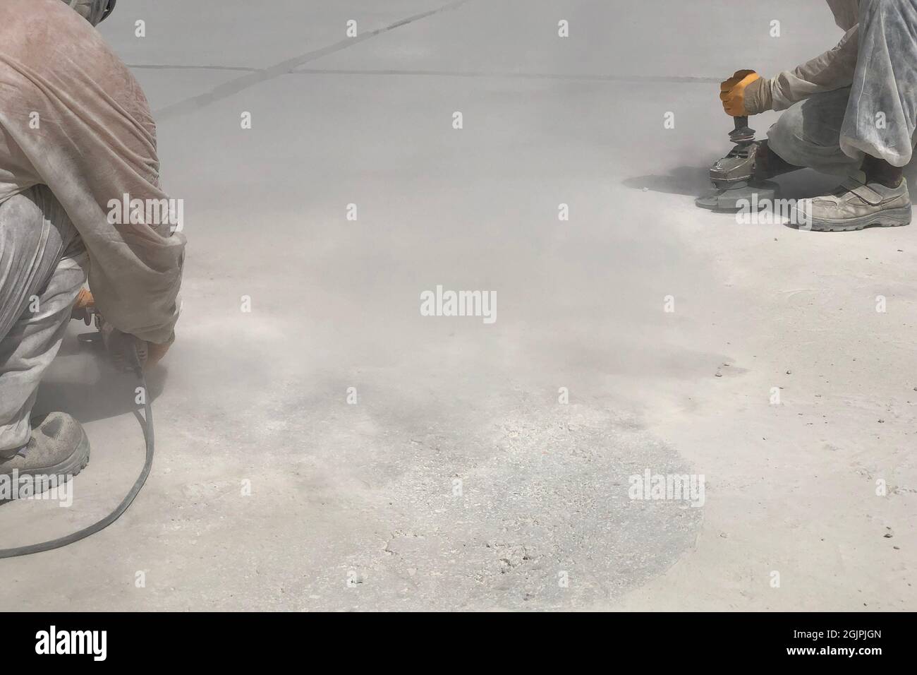 Construction workers are grinding concrete surface Stock Photo - Alamy