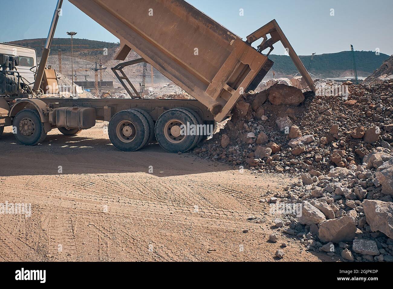 Dump truck unloads soil from truck back Stock Photo - Alamy
