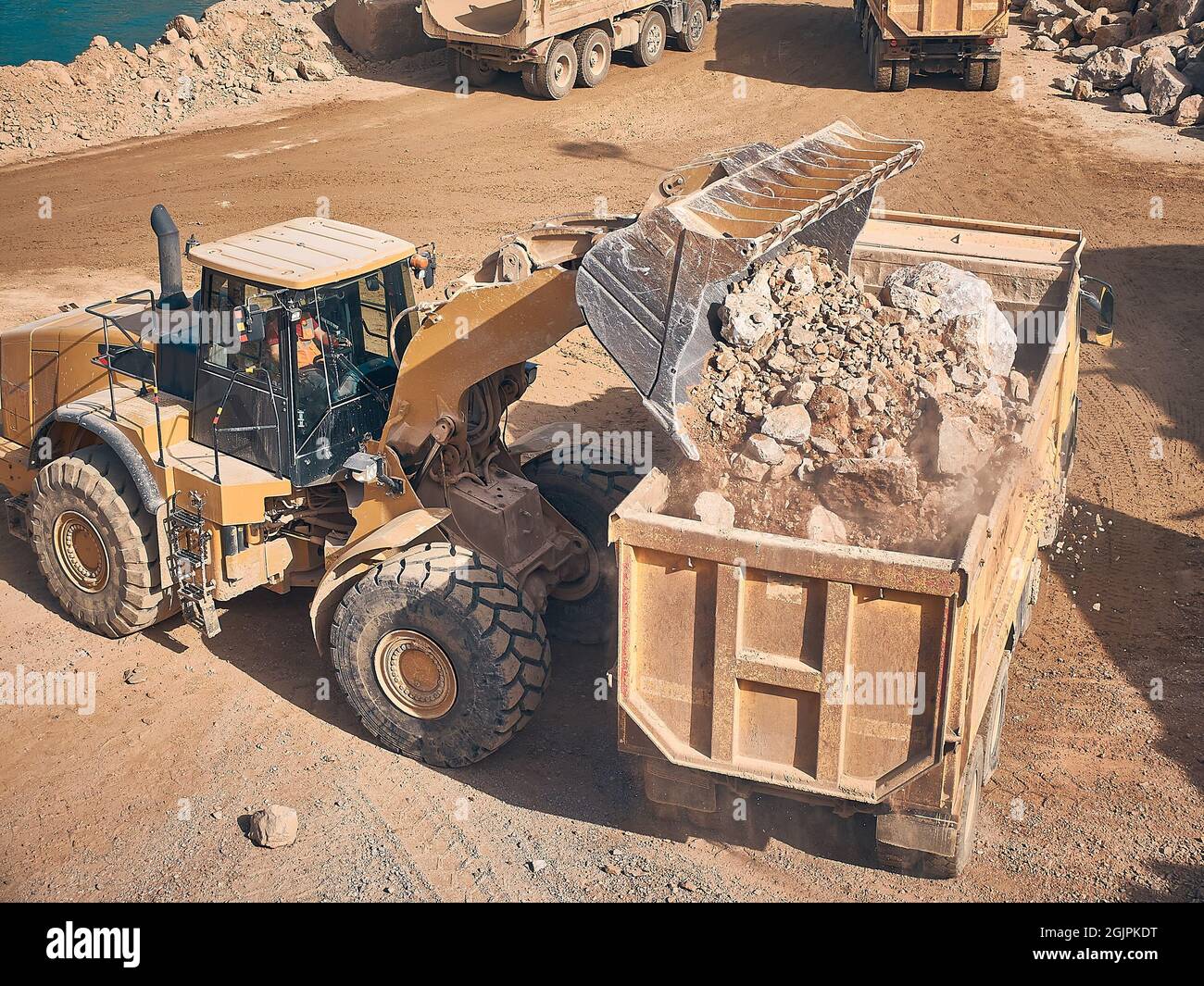 Wheel bucket loader loads truck hi-res stock photography and images - Alamy