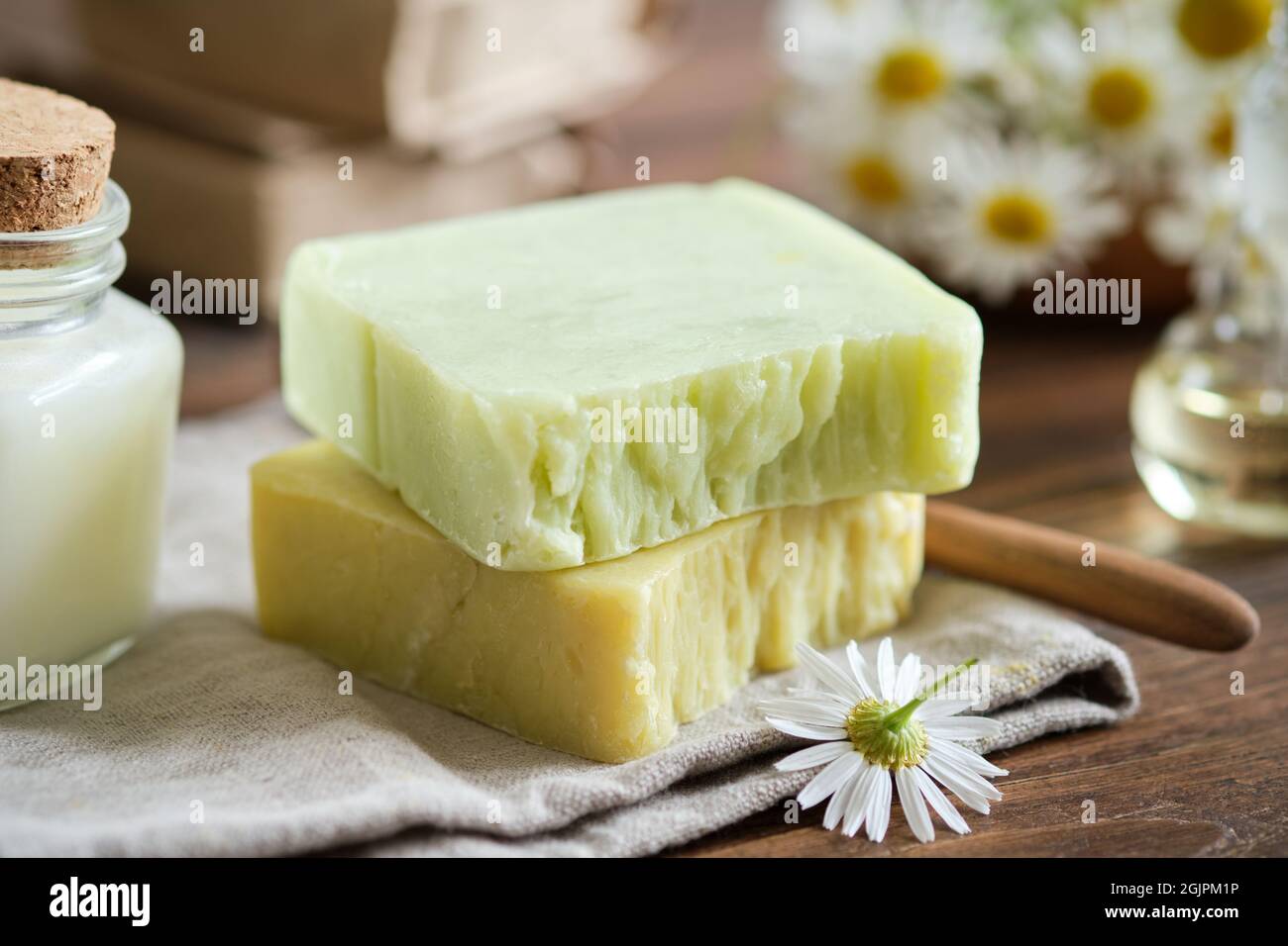 Homemade soap bars and daisy flowers. Bars of organic soap on table ...