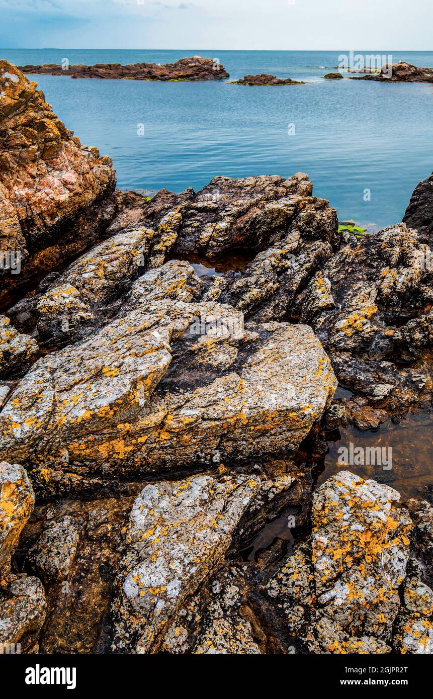 Colorful rock formation in the sea around picturesque small town ...